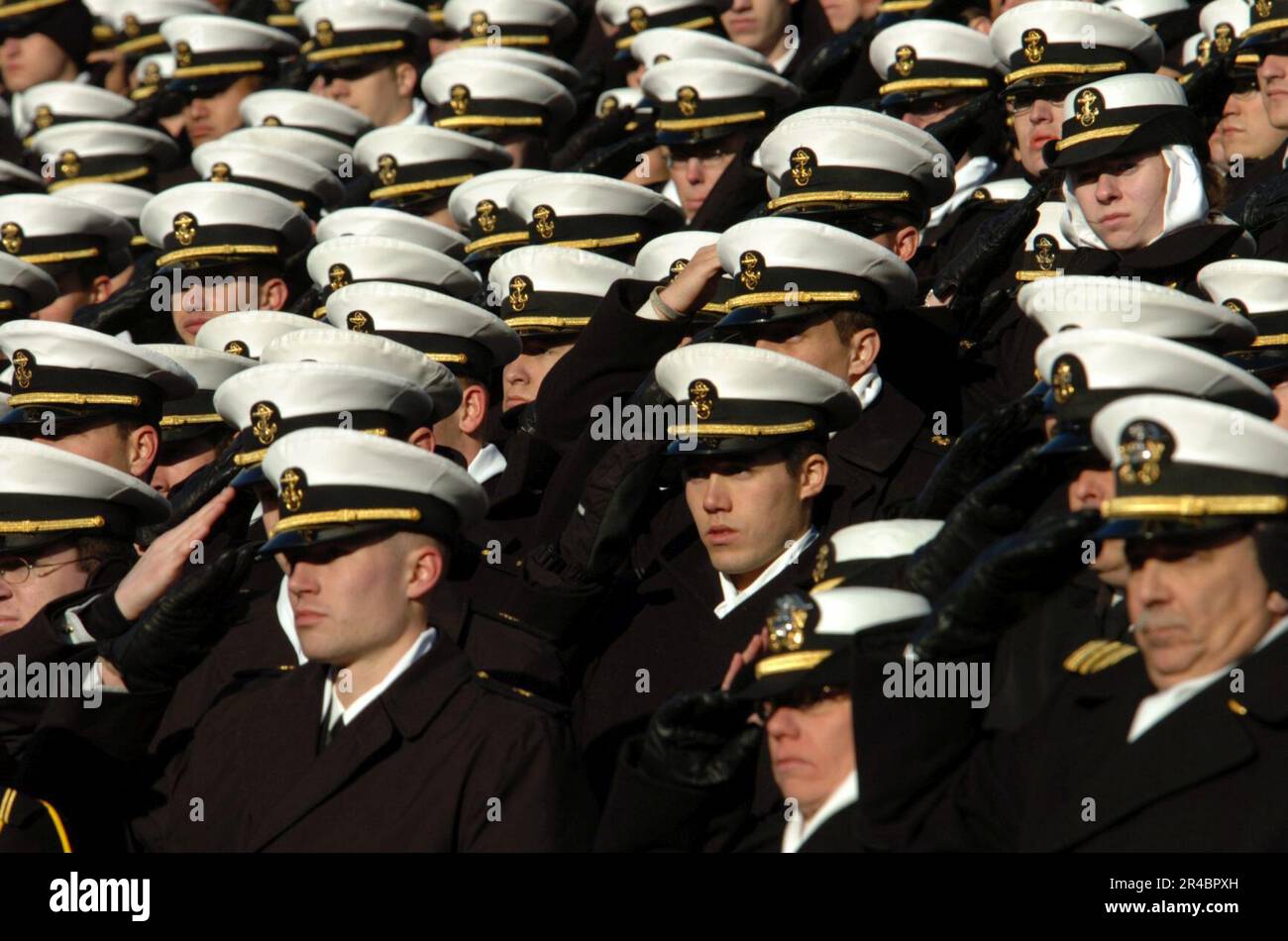 US Navy U.S. Naval Academy Midshipmen salute as the National Anthem is ...