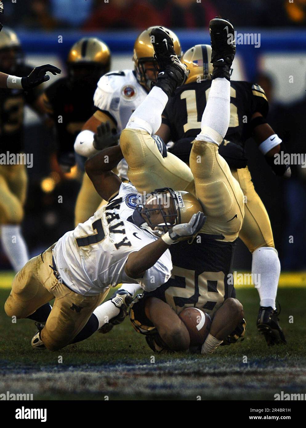 US Navy Navy slot back (7) tackles Army Running Back (82) during a punt ...