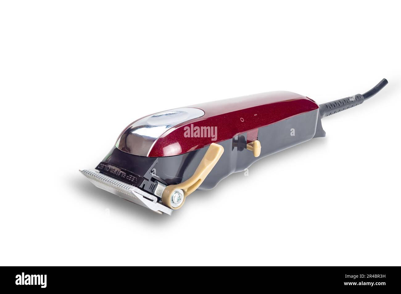 Side view of professional single red corded electric hairclipper ...