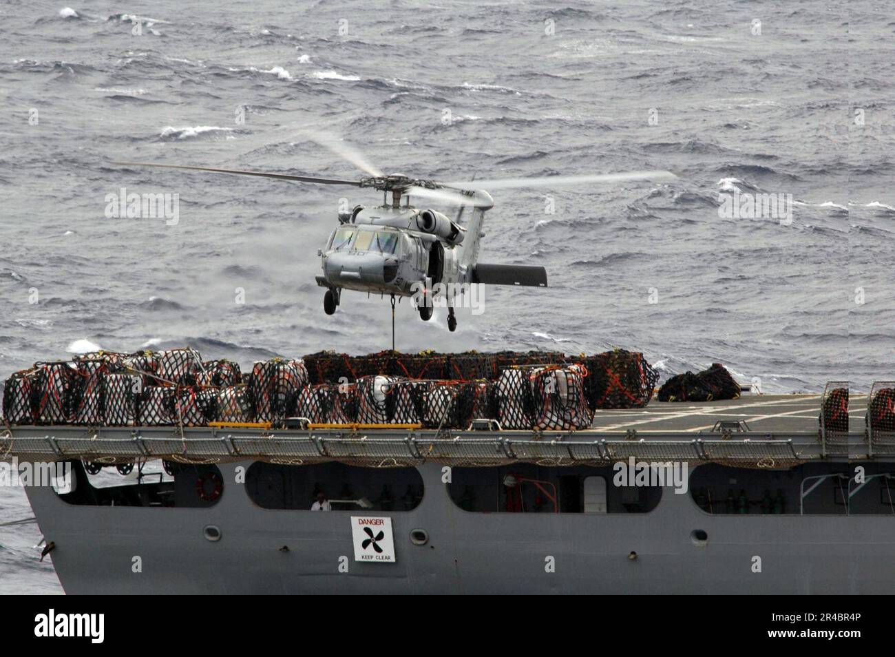 US Navy An MH-60S Seahawk helicopter transports a pallet of supplies on ...