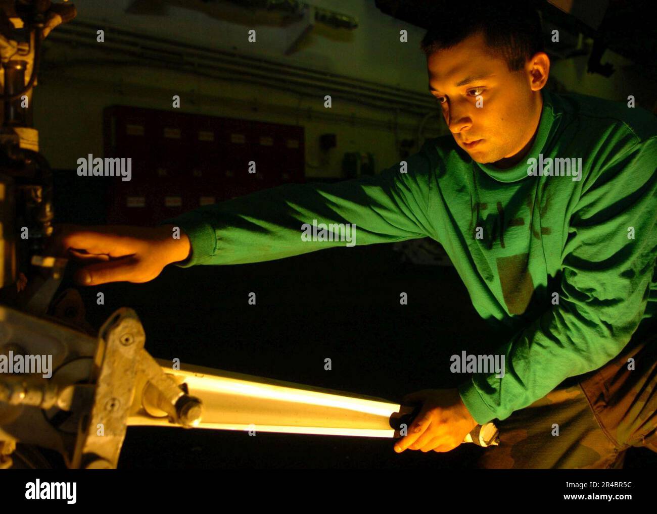 US Navy Aviation Structural Mechanic Airman inspects the launch bar and ...