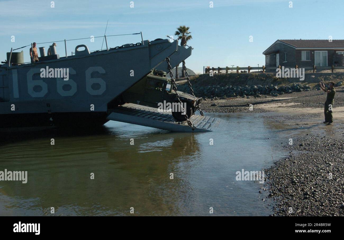 US Navy A U.S. Marine directs a humvee out of Landing Craft, Utility ...