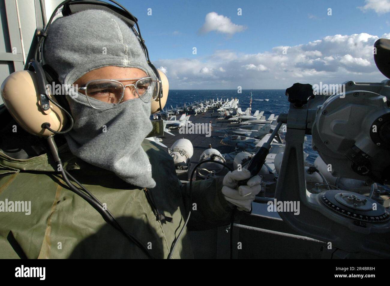 US Navy Quartermaster 2nd Class operates a sound powered phone while ...