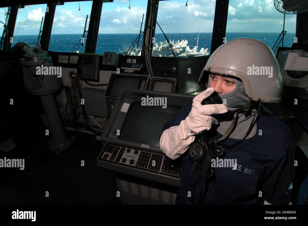 US Navy Quartermaster 3rd Class operates a sound powered telephone ...