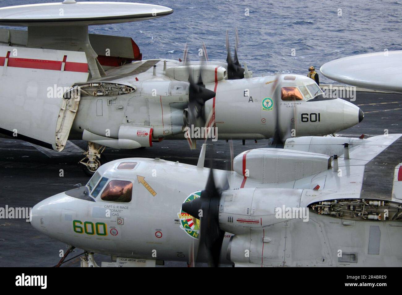 US Navy Two E-2C Hawkeyes maneuver the flight deck prior to a launch ...