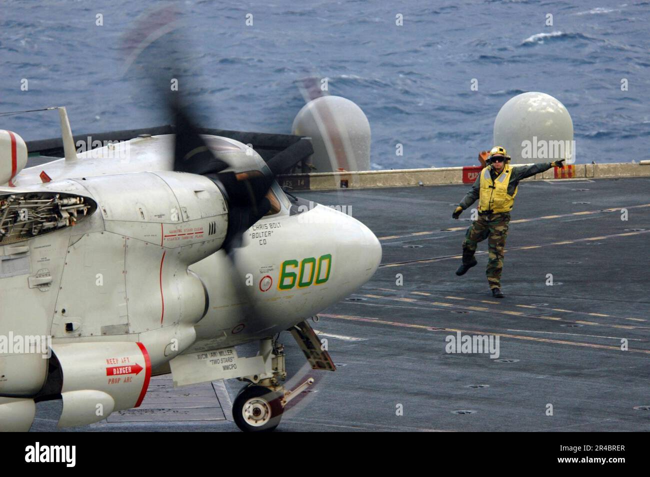 US Navy An Air Department member directs an E-2C Hawkeye on the flight ...