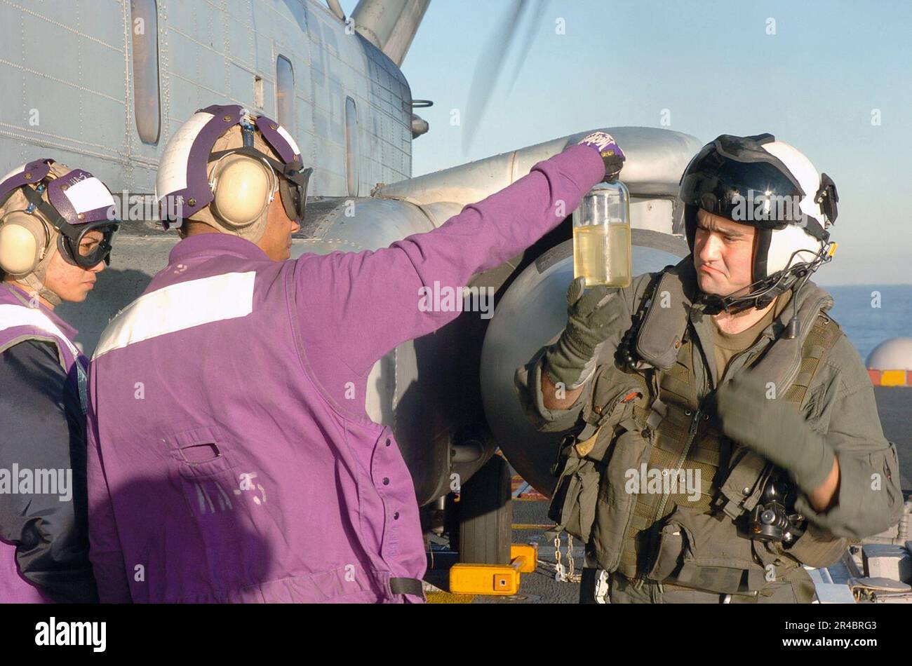 US Navy A Marine co-pilot inspects a JP-5 fuel sample aviation ...