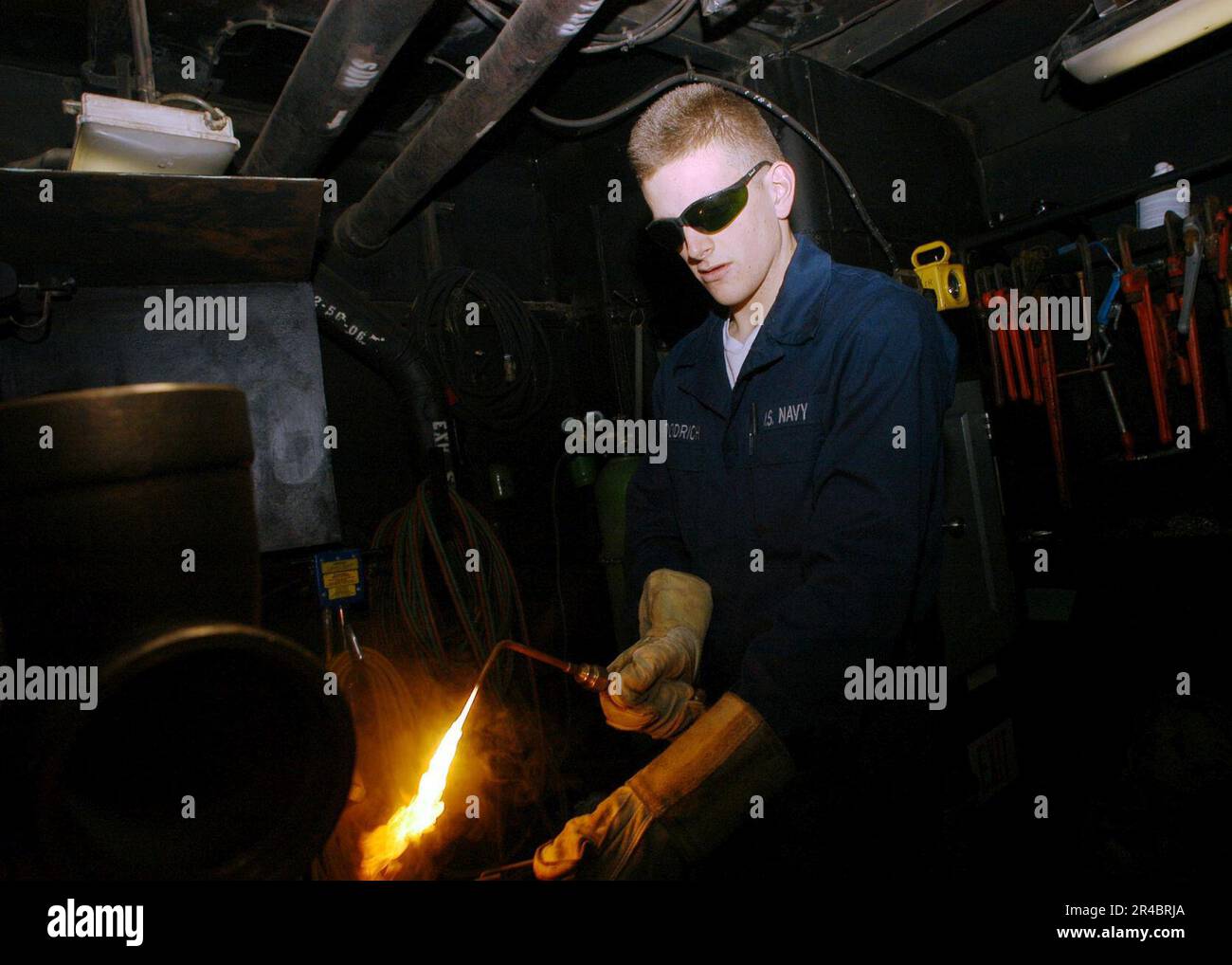 US Navy Hull Maintenance Technician Fireman lights a brazing torch in ...