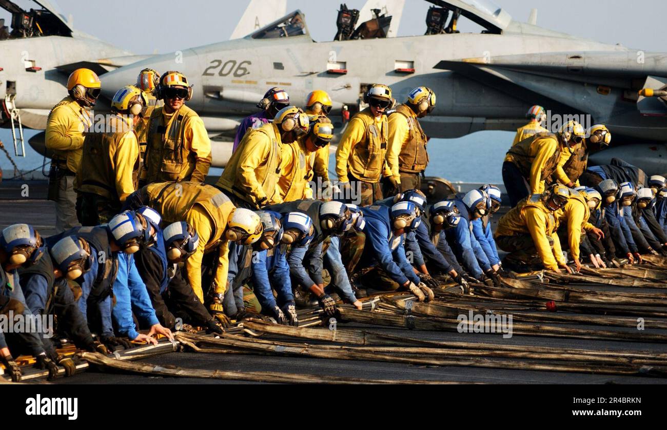 US Navy Flight deck personnel participate in an aircraft barricade ...