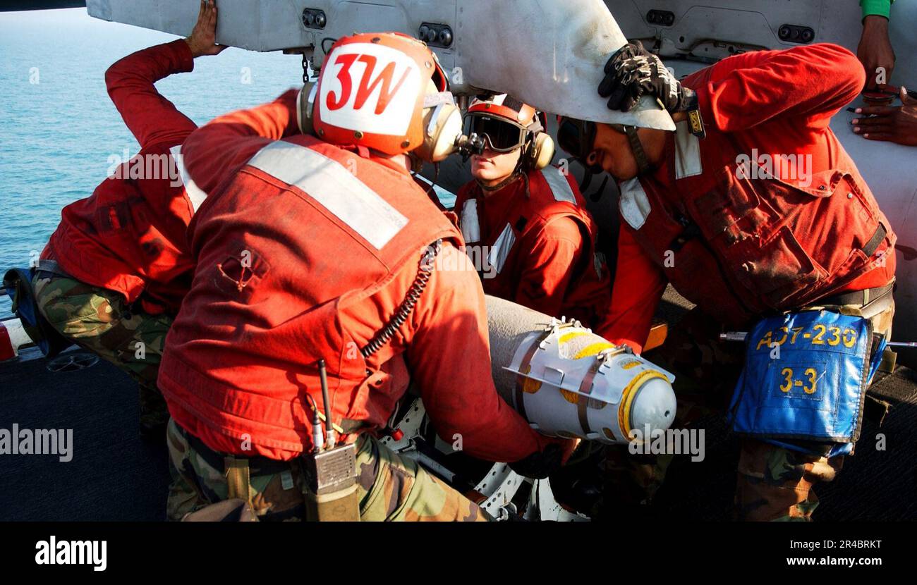 US Navy Aviation Ordnancemen upload a GBU-38 500-pound satellite guided ...