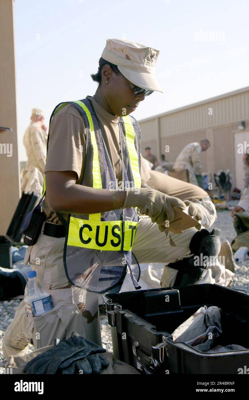 US Navy U.S. Navy Storekeeper 2nd Class inspects U.S. Army personnel ...