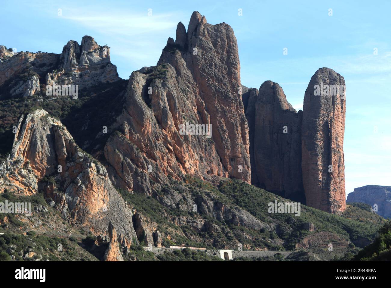 A landscape of rugged terrain featuring a cluster of jagged rocks ...