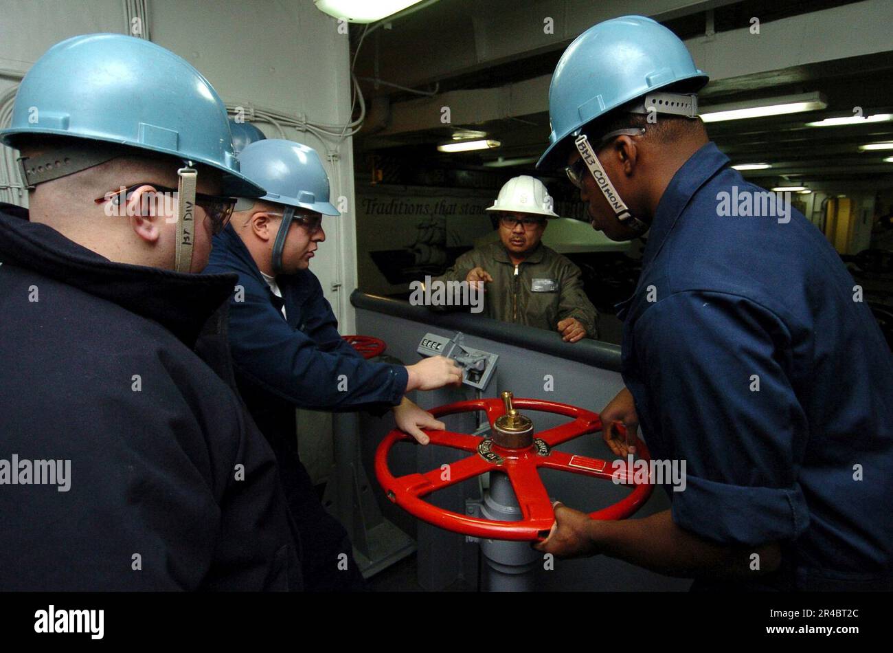 US Navy Chief Boatswain's Mate center, instructs Sailors on the proper ...