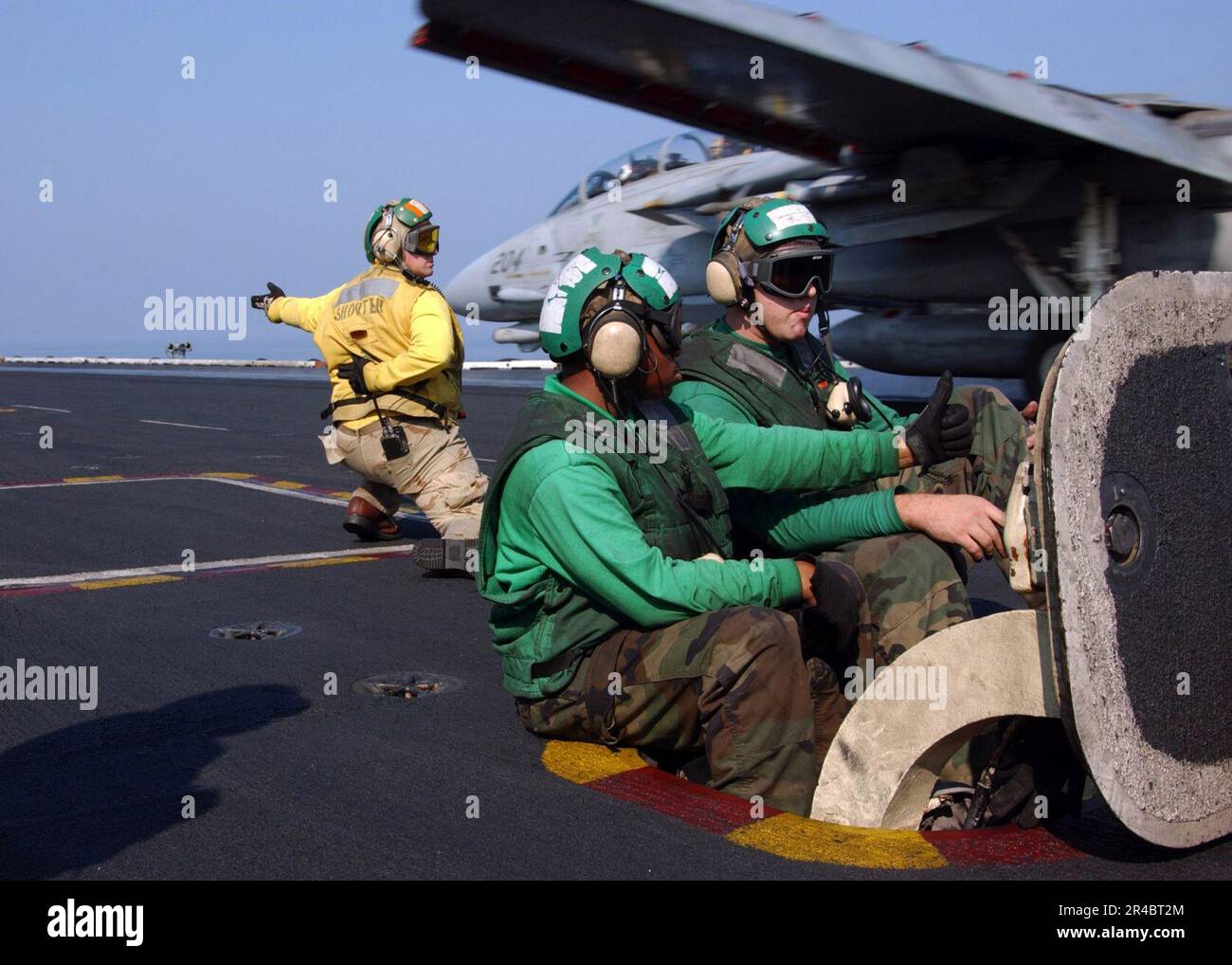 US Navy Lt. Cmdr. signals to launch an F-14D Tomcat Stock Photo - Alamy