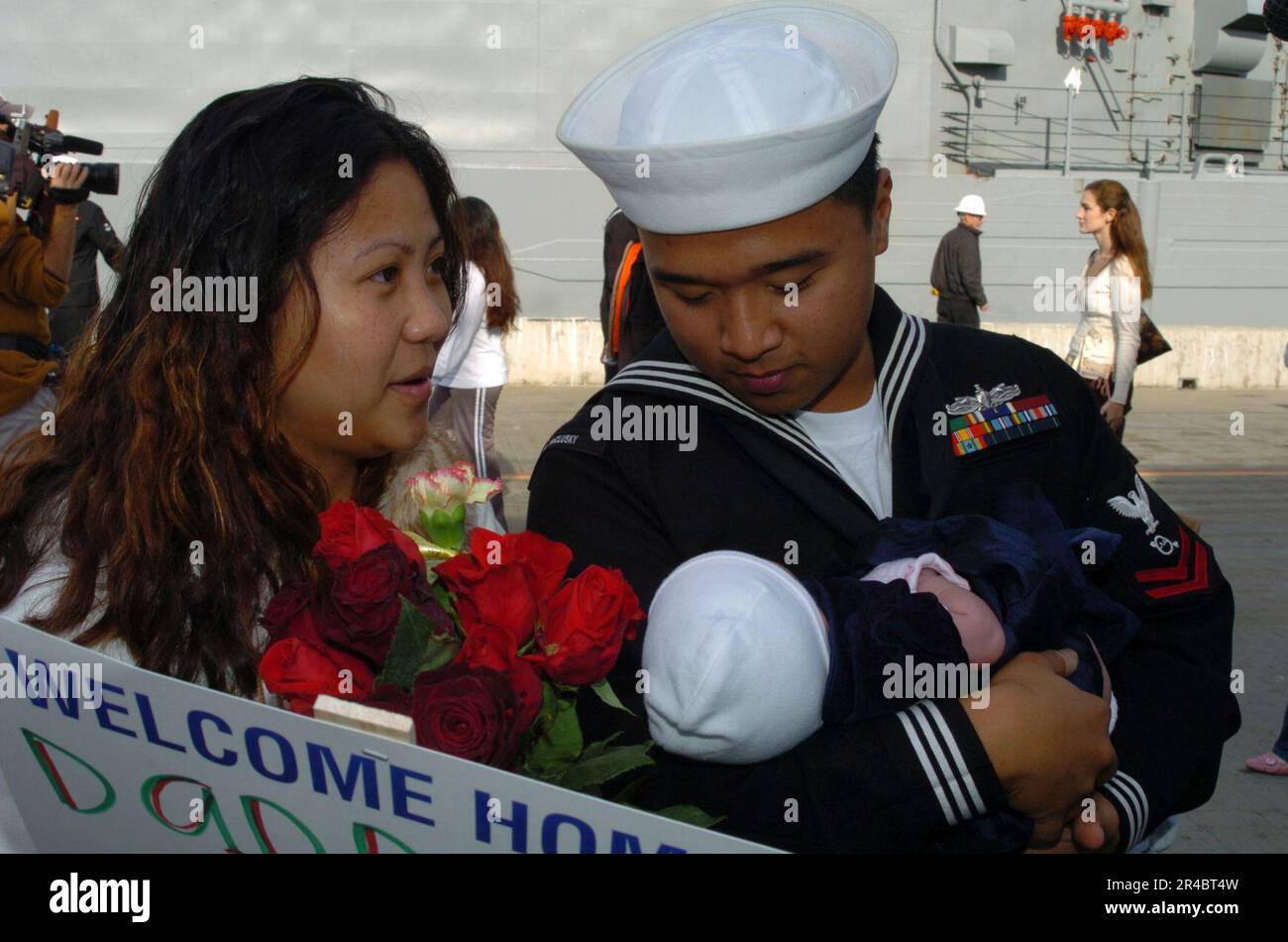 US Navy Operations Specialist greets his wife and daughter after ...