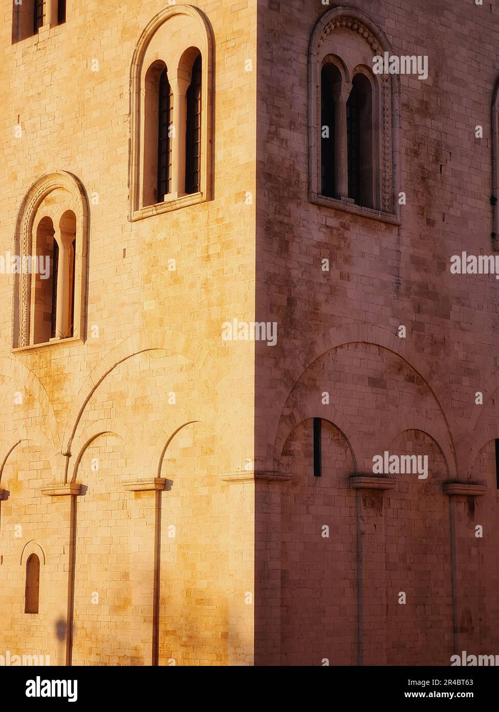 A detail of ancient cathedral with symmetrical facades with sunlight ...