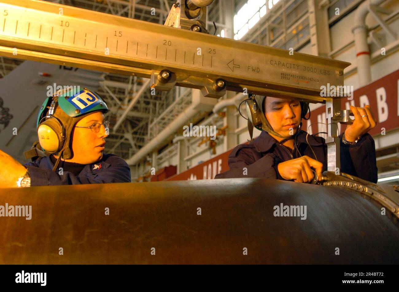 US Navy Aviation Machinist Mate 3rd Class prepare to connect an engine ...