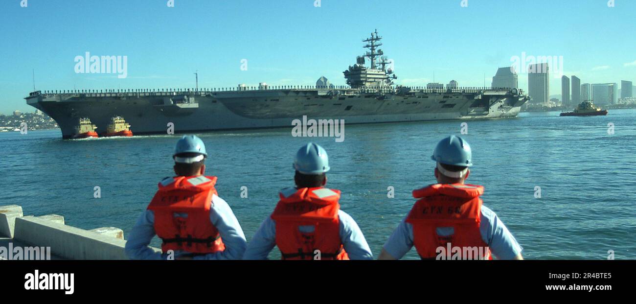 US Navy Sailors aboard the USS Ronald Reagan (CVN 76) man the rail as ...