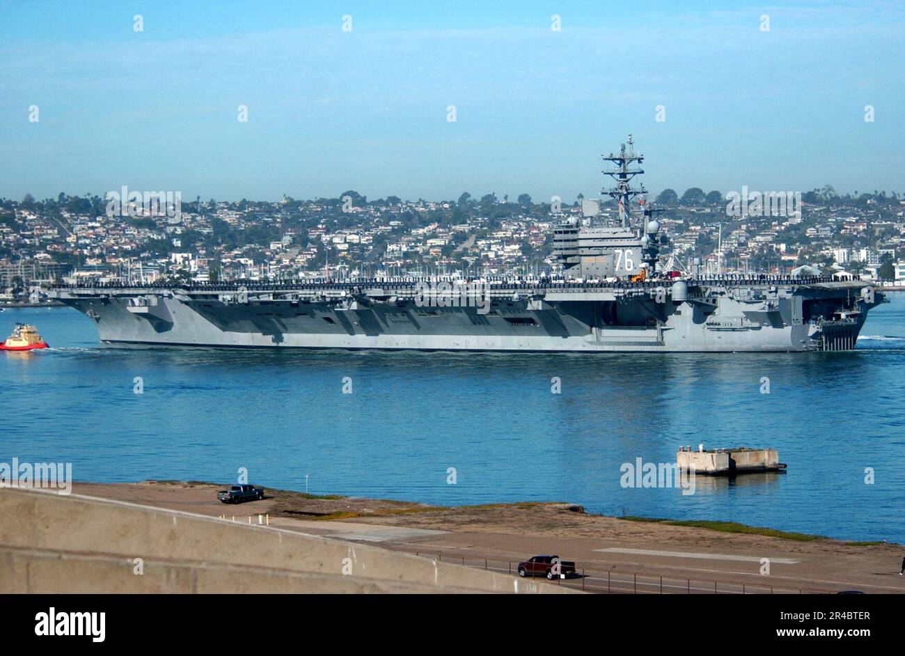 US Navy Sailors aboard the USS Ronald Reagan (CVN 76) man the rails as ...