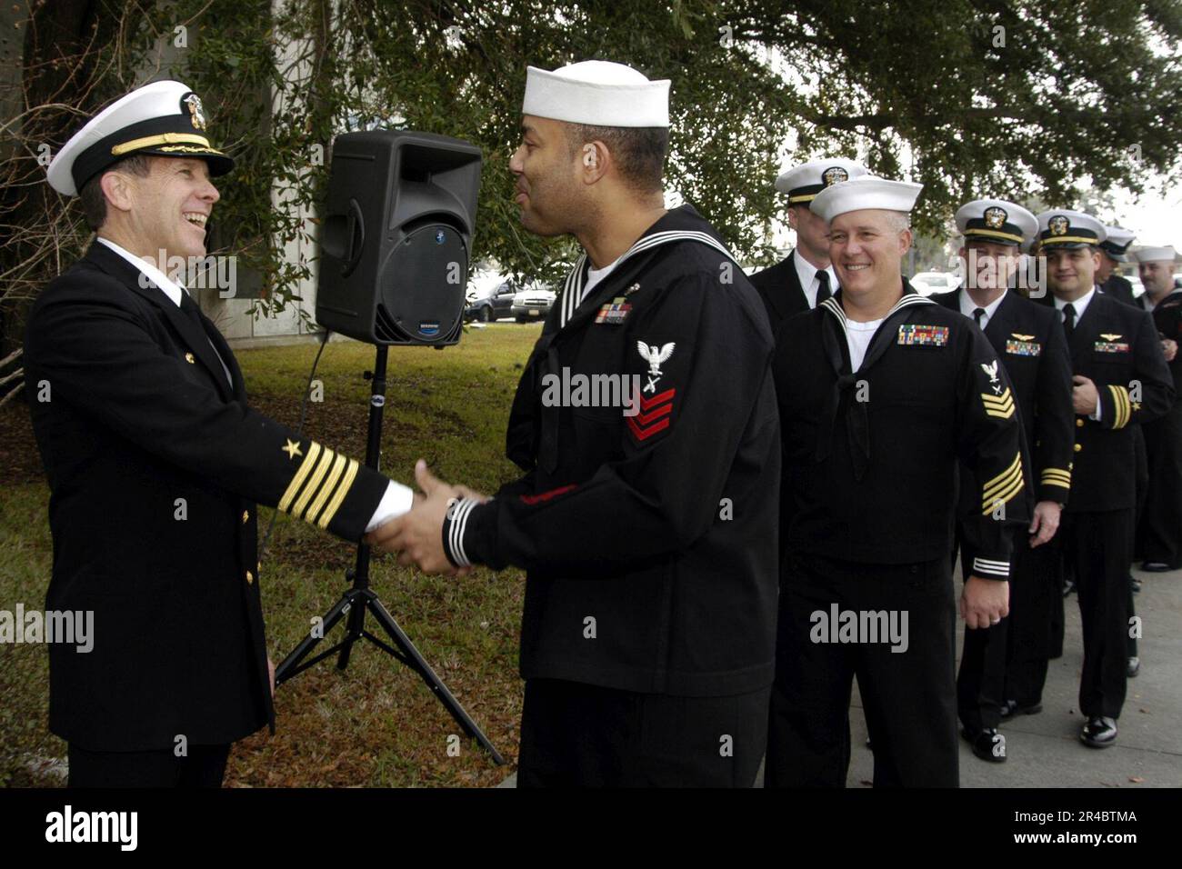 US Navy Gunner's Mate 1st Class congratulates and bids farewell to Capt ...