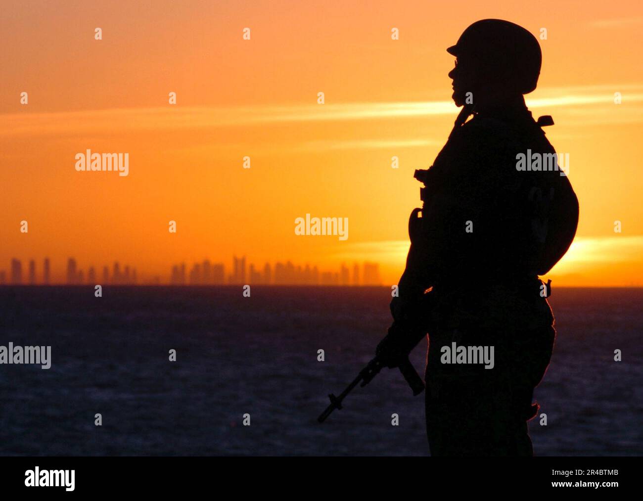 US Navy Master-at-Arms 2nd Class stands watch on the flight deck during ...
