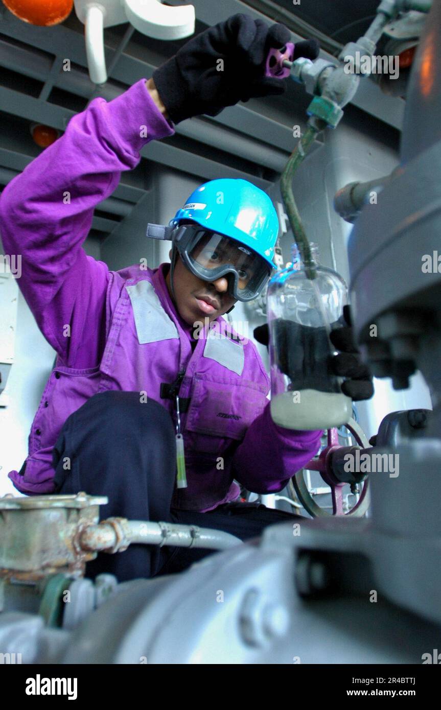 US Navy Aviation Boatswain's Mate Fuels Airman tests fuel for color and ...