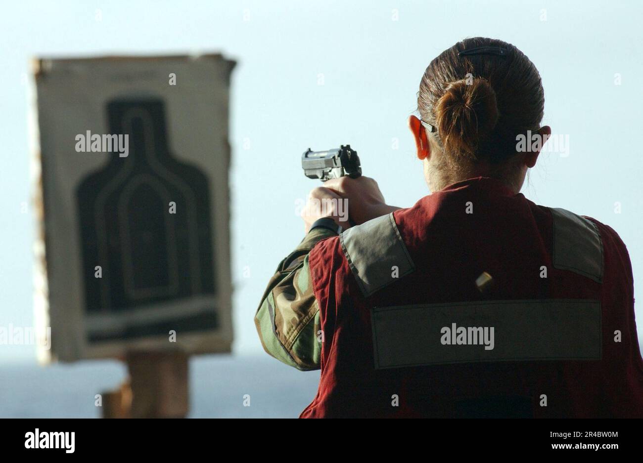 US Navy Master-at-Arms 2nd Class fires a 9mm Beretta handgun during ...