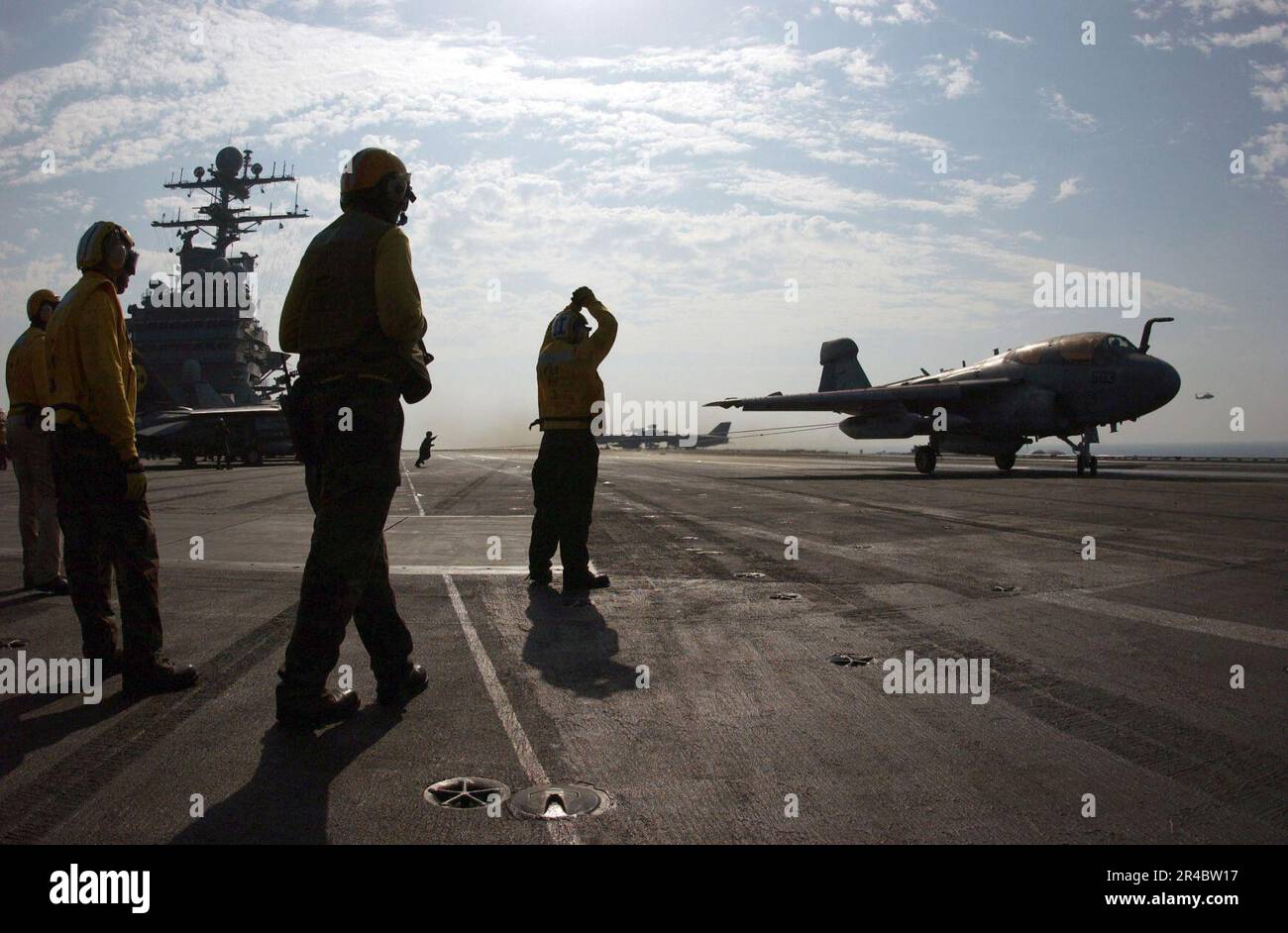 US Navy Flight deck personnel observe as an EA-6B Prowler assigned to ...