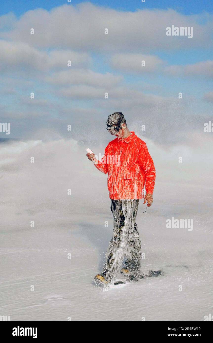 US Navy Airman assigned to Air Department inspects a sample of Aqueous ...