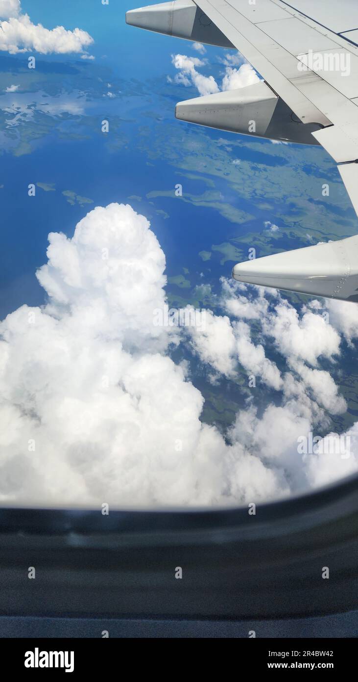 An aerial view of the ocean and continent seen from an airplane window ...