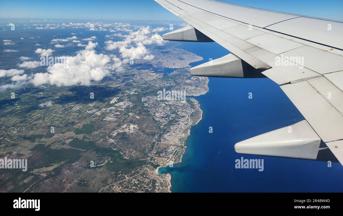 An aerial view of the ocean and continent seen from an airplane window ...