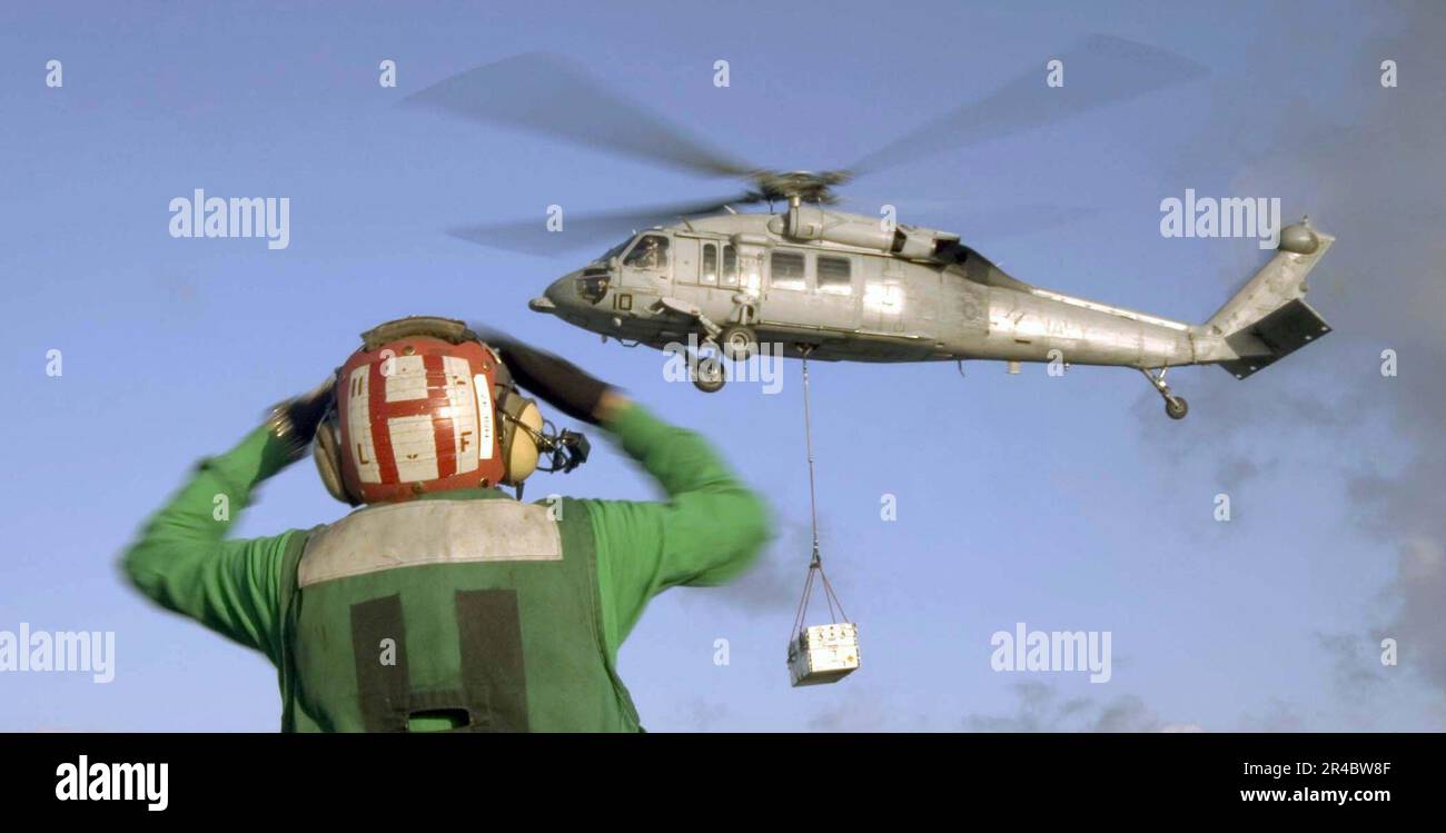 US Navy A landing signal enlisted directs a MH-60S Seahawk helicopter ...