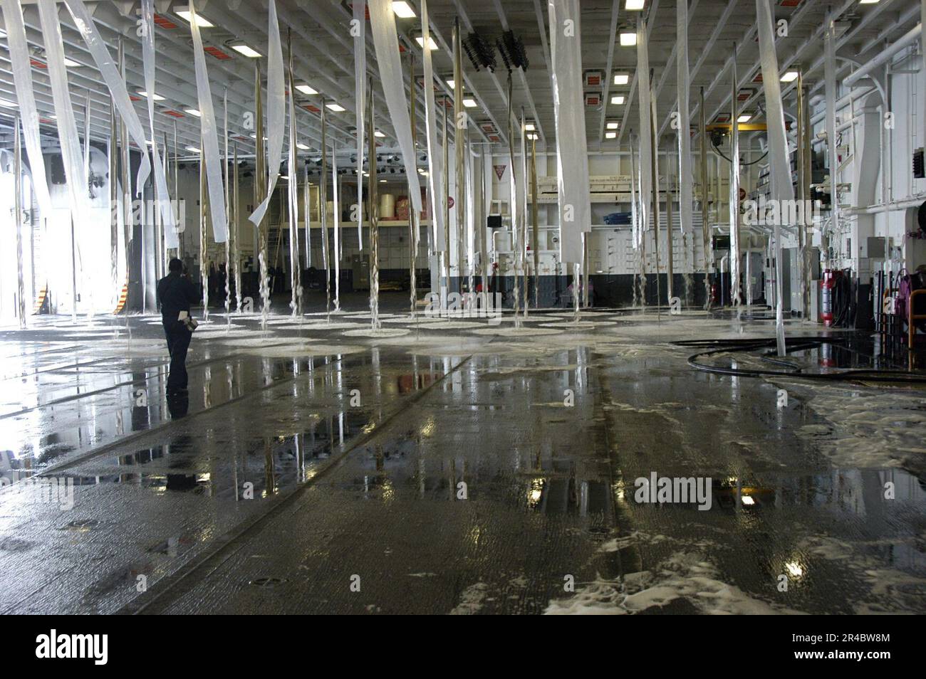US Navy Damage Controlman 1st Class checks to ensure nozzles are ...
