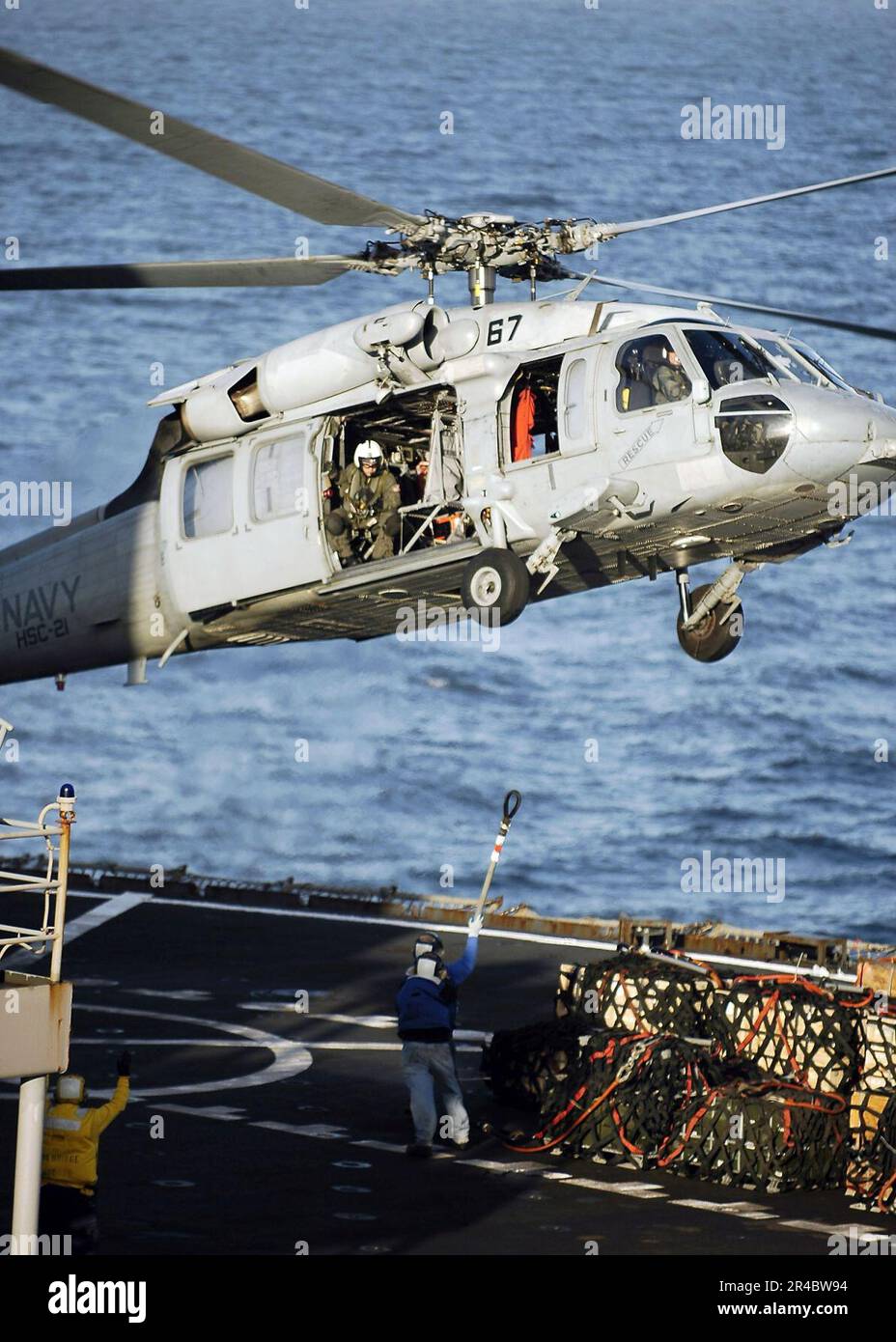 US Navy A helicopter assigned to Sea Combat Squadron Two One (HSC-21) prepares to pick up ...
