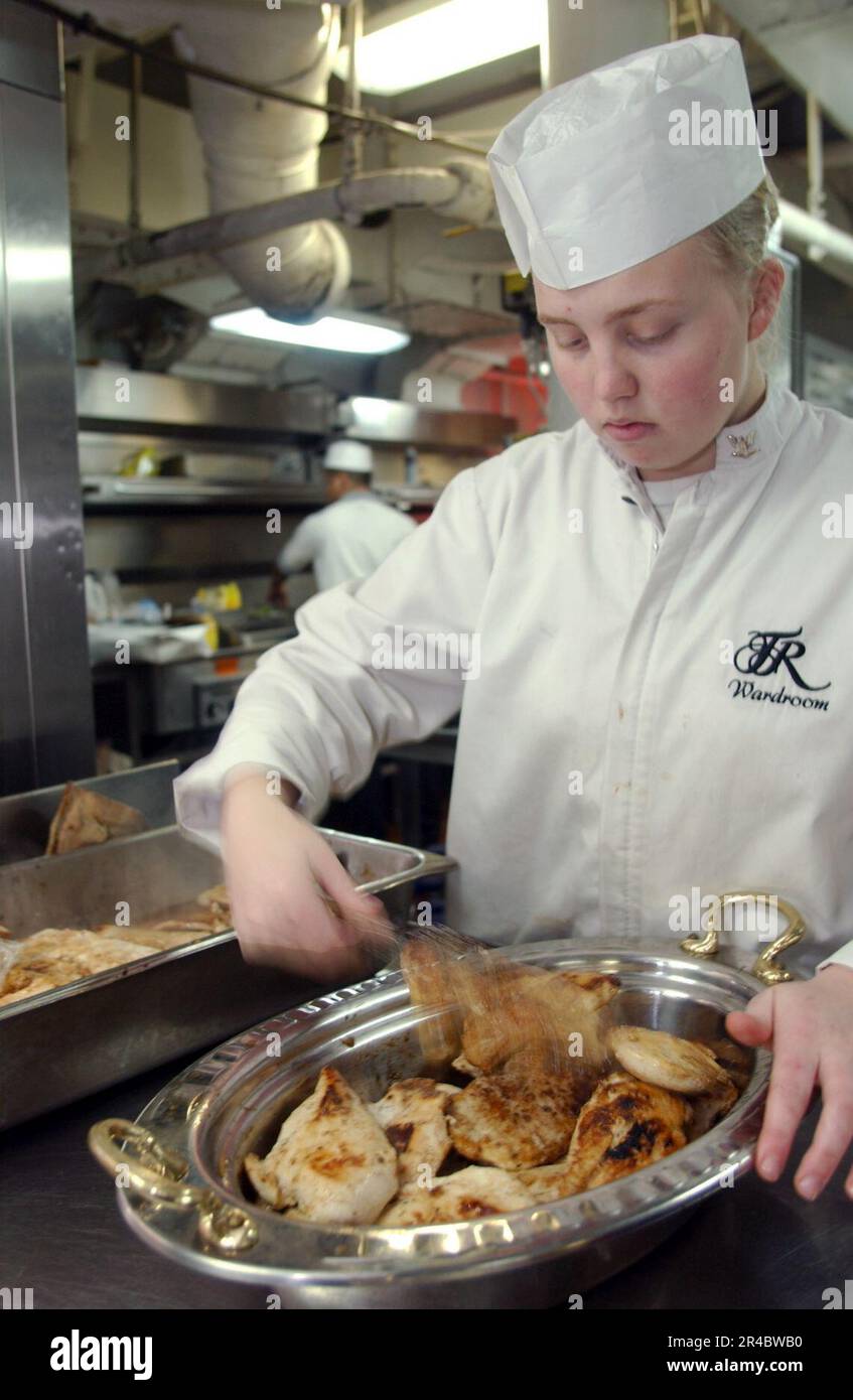 US Navy Air Traffic Controller 3rd Class prepares chicken for the ...