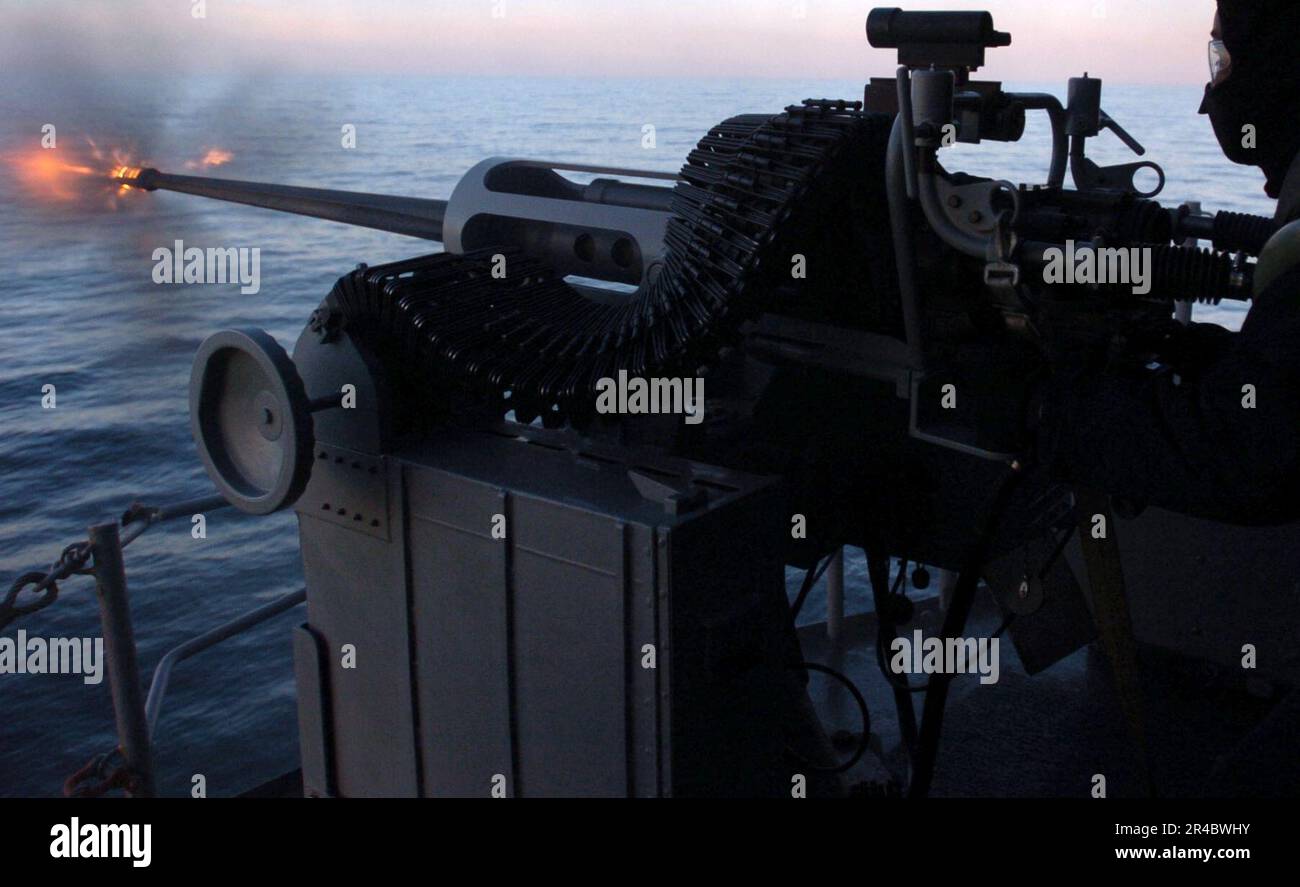 US Navy Airman fires a MK-38 25 mm machine gun during a familiarization ...