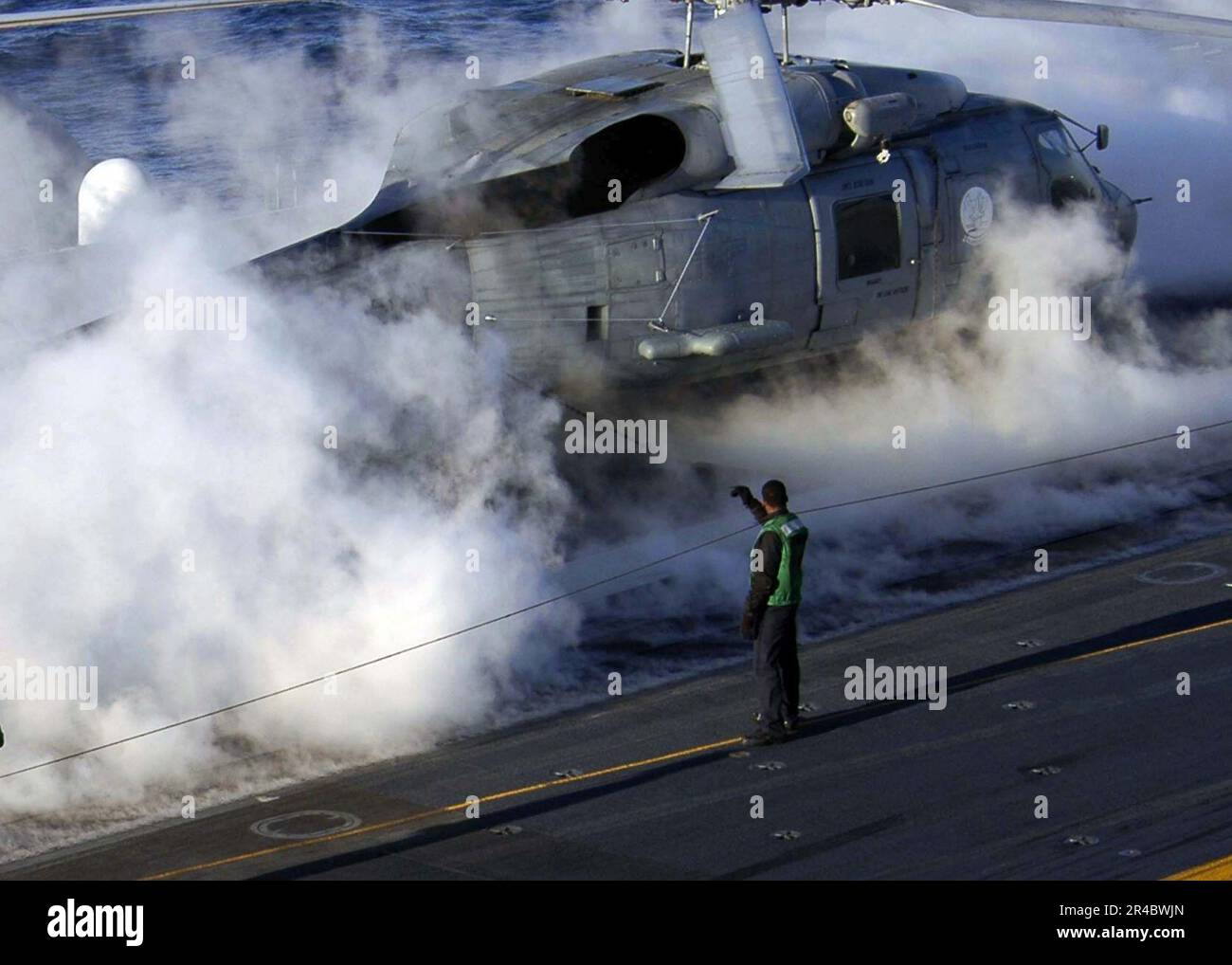 US Navy Air Department personnel stand a safety watch for a no load ...