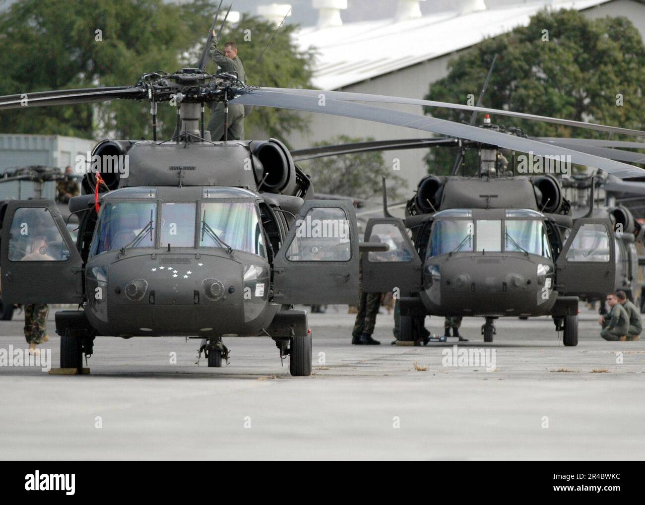 US Navy U.S. Army UH-60 Blackhawk helicopters prepare to take off from ...