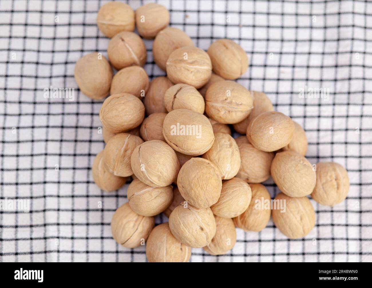 A lot of whole walnuts on a napkin close-up. Healthy, organic and ...