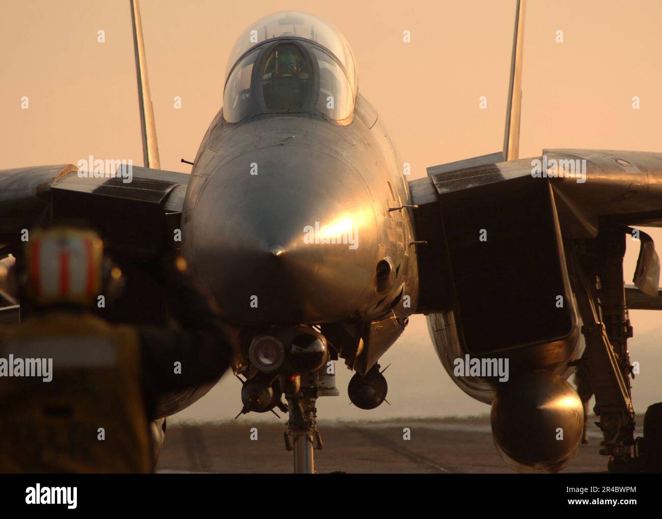 US Navy An F-14 Tomcat is directed to the steam-powered catapult prior ...