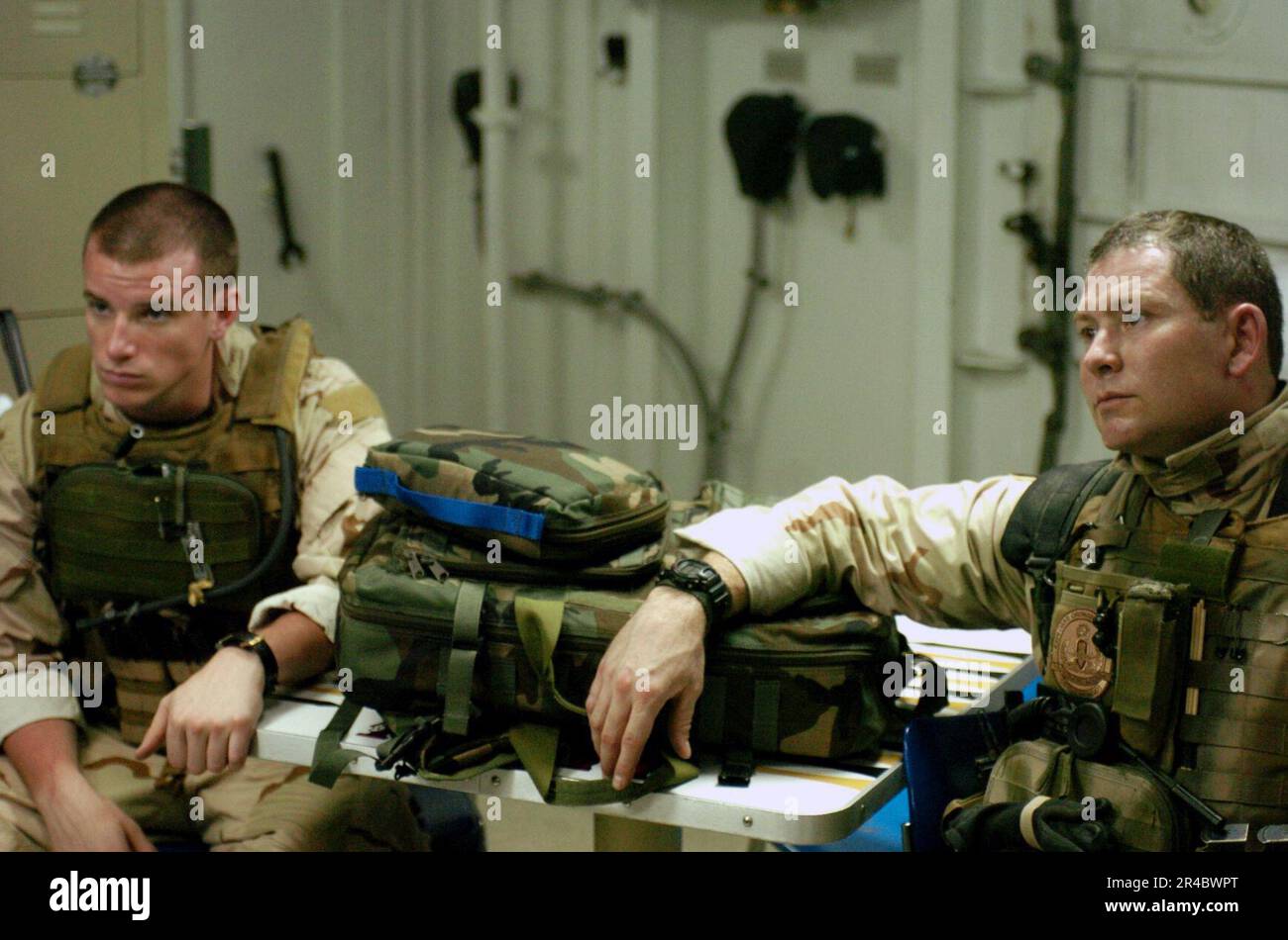 US Navy Master-at-Arms 2nd Class left, and Equipment Operator 1st Class ...