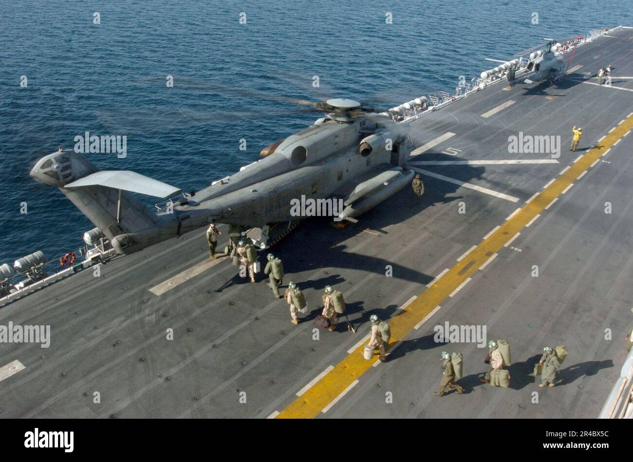 US Navy Marines board a CH-53E Super Stallion helicopters, assigned to ...