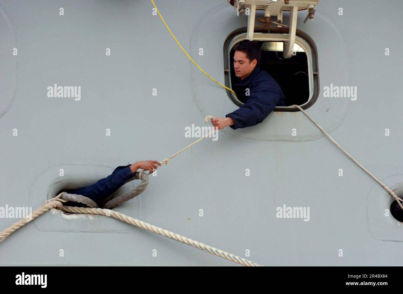US Navy Line handlers assigned the amphibious transport dock ship USS ...