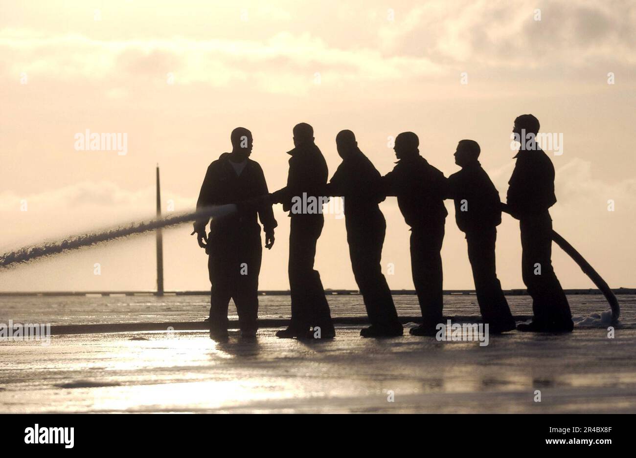 US Navy Crew members discharge Aqueous Film Forming Foam (AFFF) onto ...