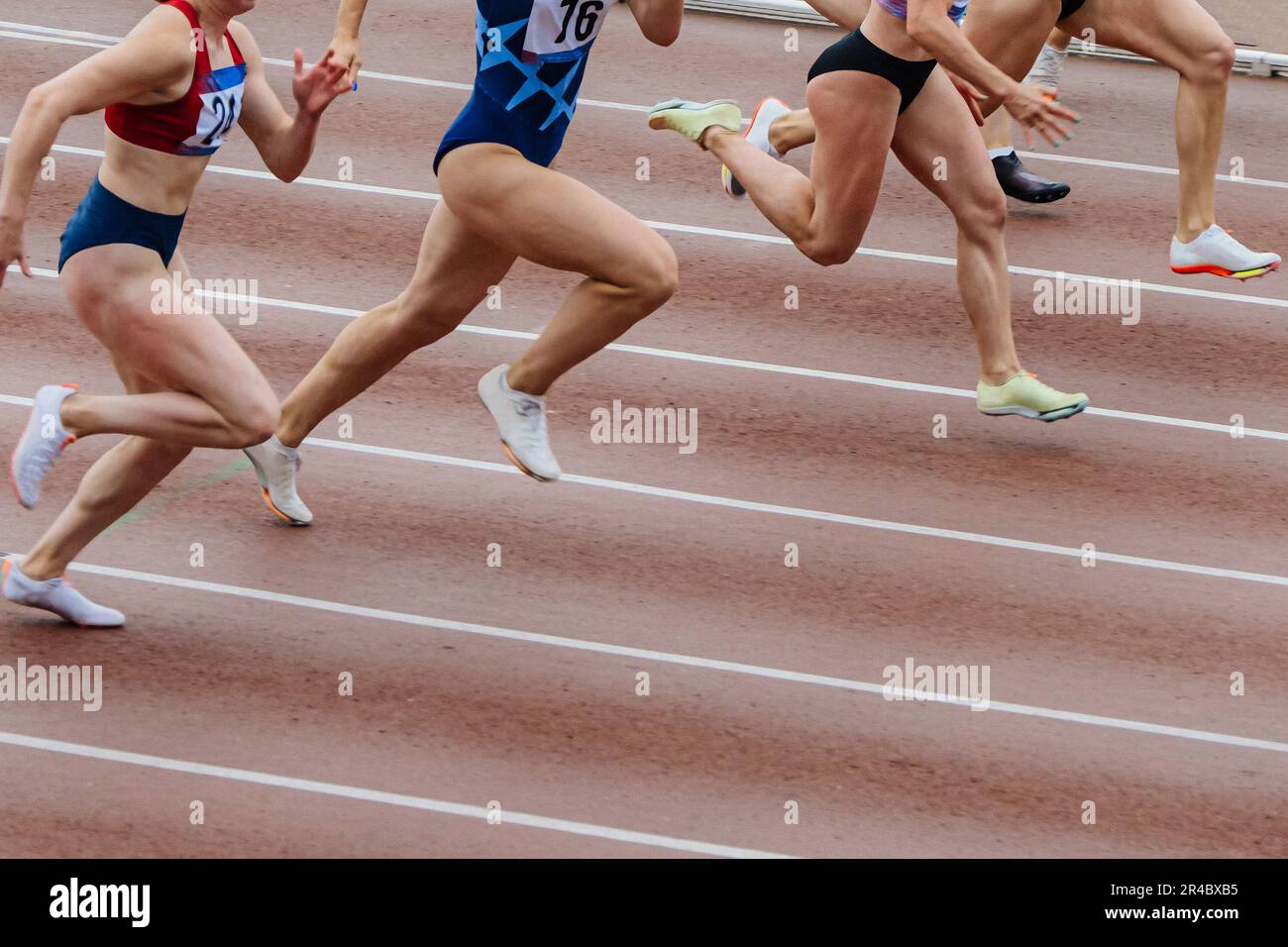 group female athletes runners running together sprint race in track ... group female athletes runners running together sprint race in track ...