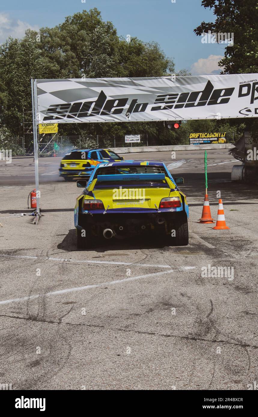 A rally car driving over the finish line, reaching the end of the ...