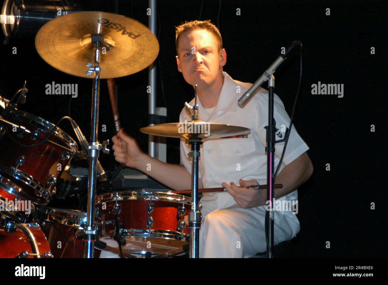 US Navy Musician 2nd Class plays the drums during a performance at ...