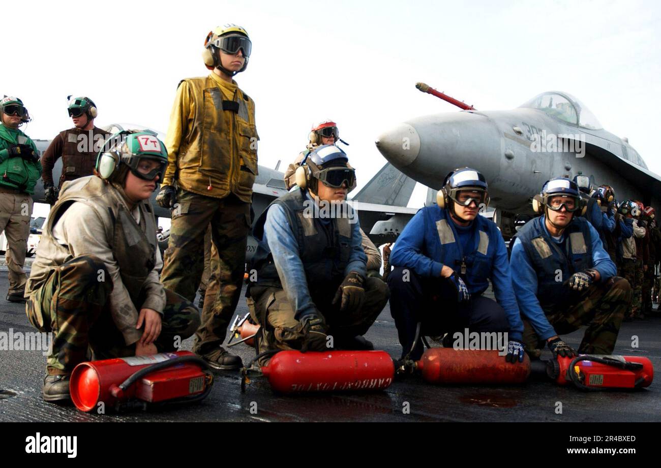 US Navy Flight deck personnel participate in an aircraft fire drill on ...
