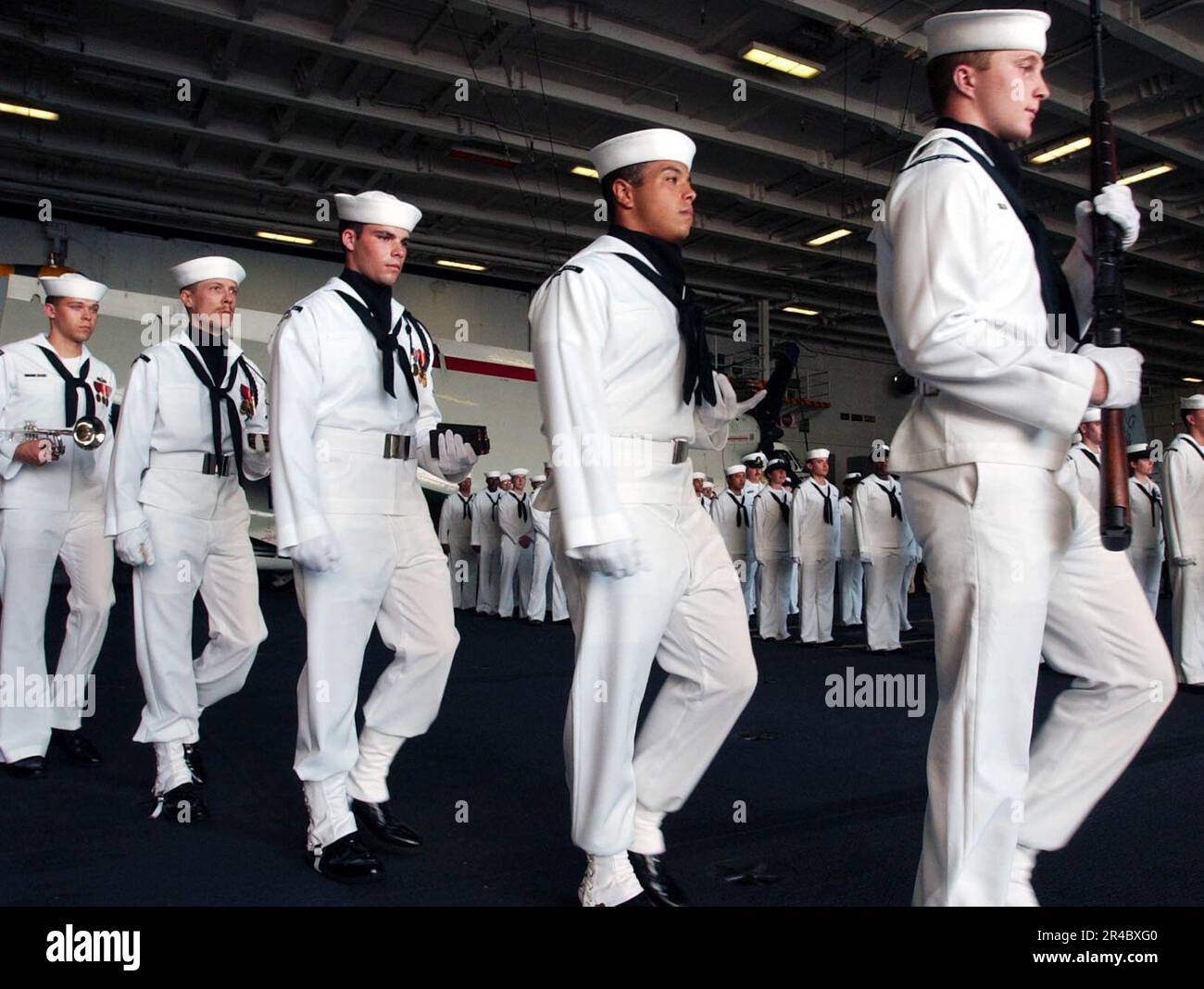 US Navy Members from the honor guard march during a burial at sea ...
