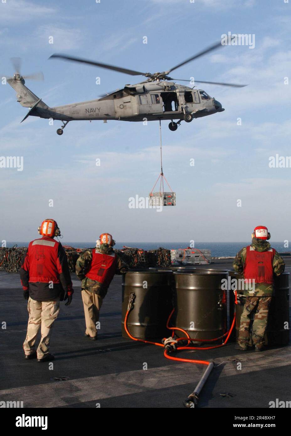 US Navy Weapons Department personnel standby during a vertical ...